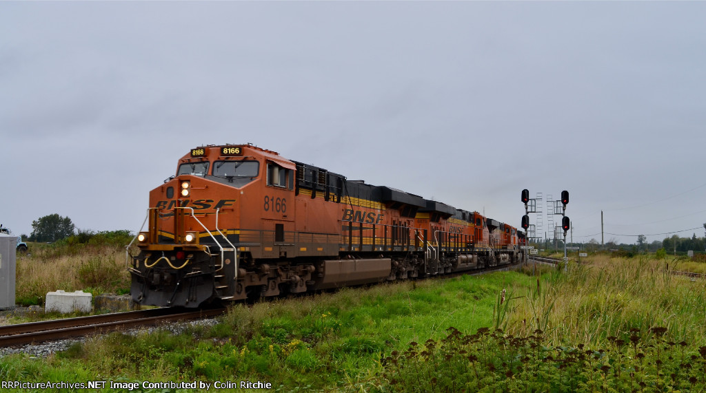 BNSF 8166/6875/7800/1083/CN 8828/BNSF 6918 leading a SB mixed freight consist into the Mud Bay ...